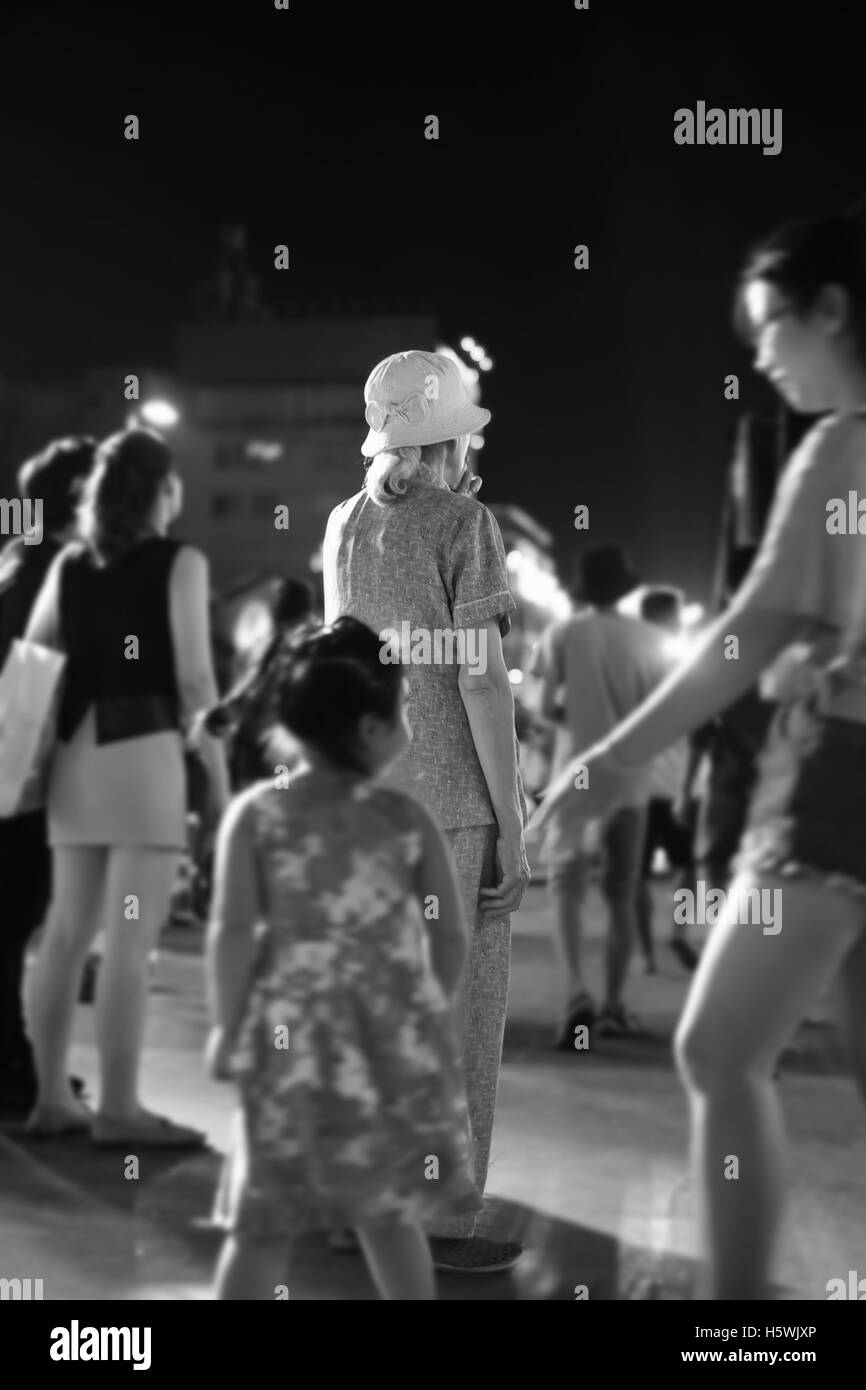 Old woman/lady standing alone in the street Stock Photo - Alamy
