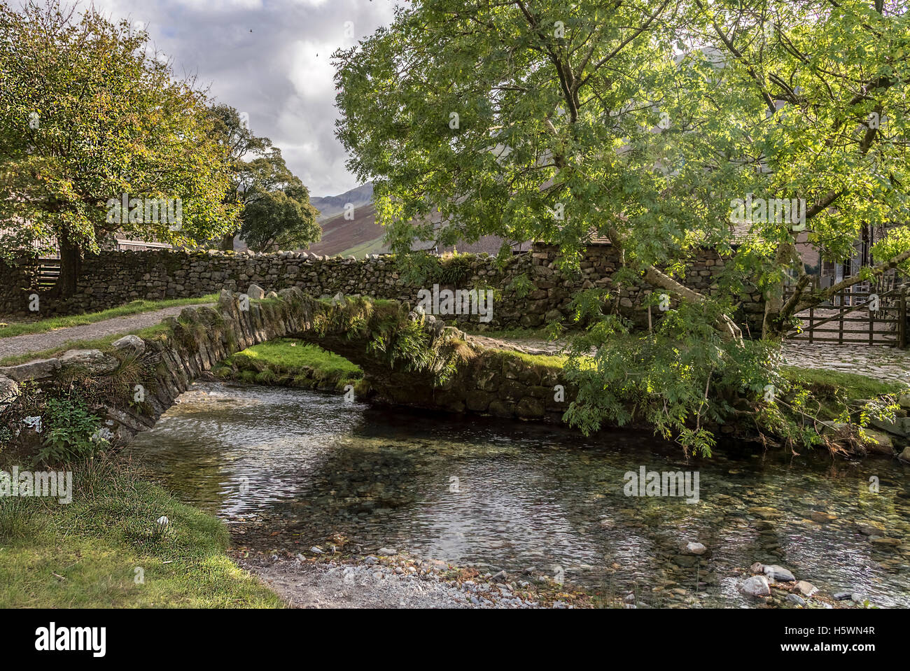 An ancient stone bridge over the beck at Wasdale Head. The Lake ...