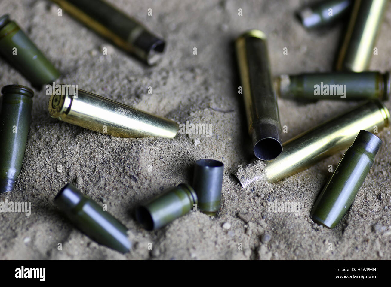 bullet in the sand Stock Photo - Alamy