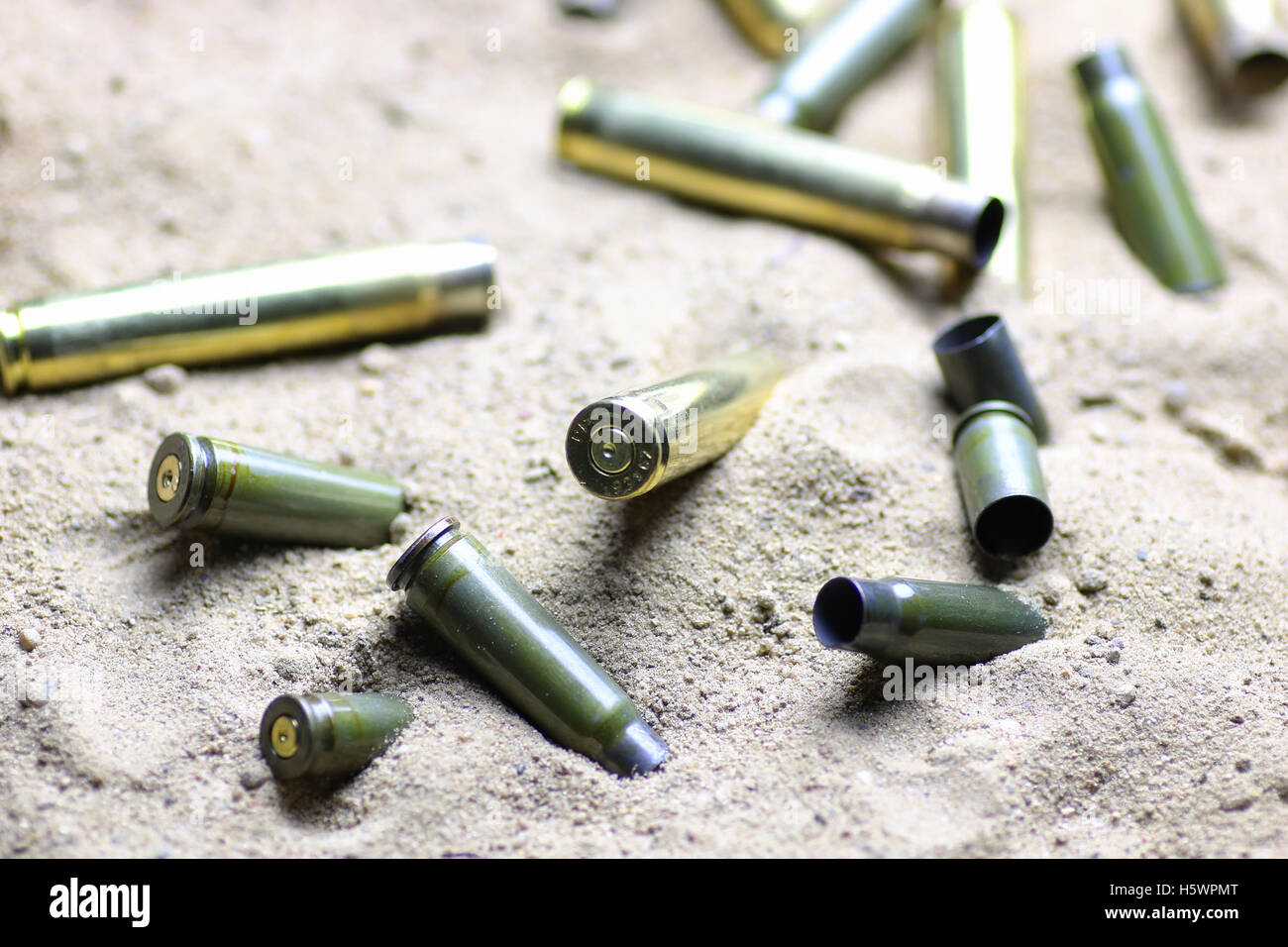 bullet in the sand Stock Photo - Alamy