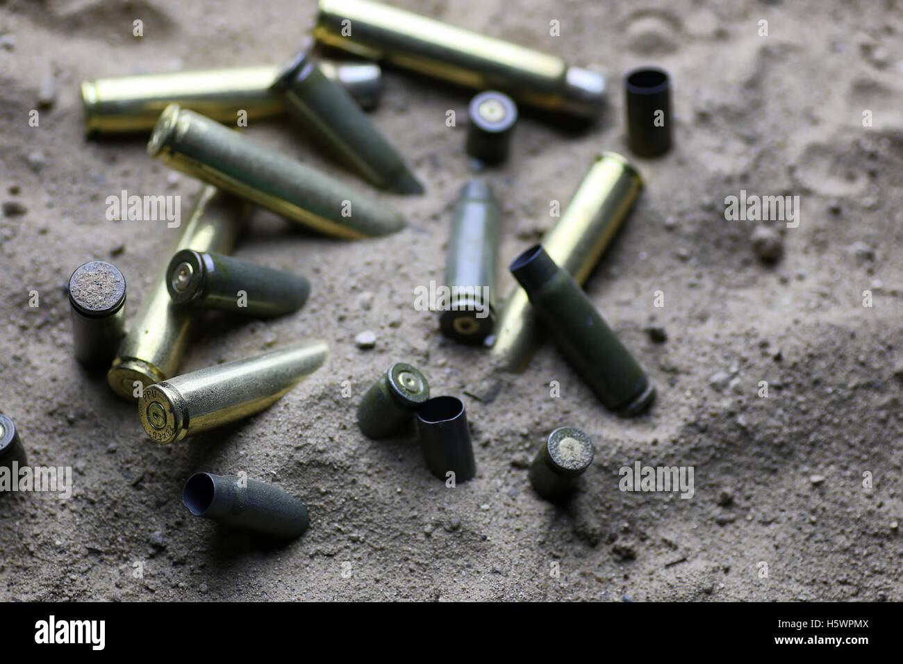 bullet in the sand Stock Photo - Alamy