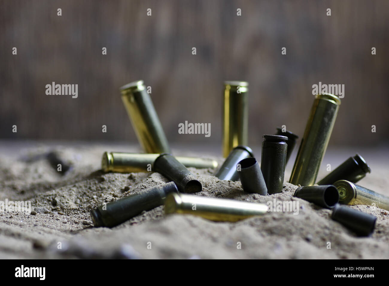 bullet in the sand Stock Photo - Alamy