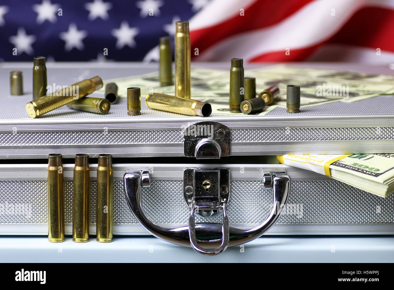 bullet and money dollar on the silver case Stock Photo - Alamy