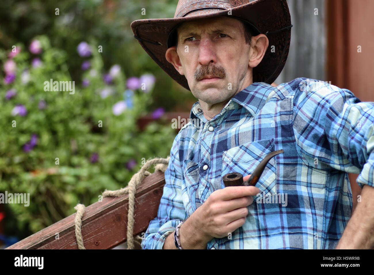 cowboy man smoke pipe Stock Photo - Alamy