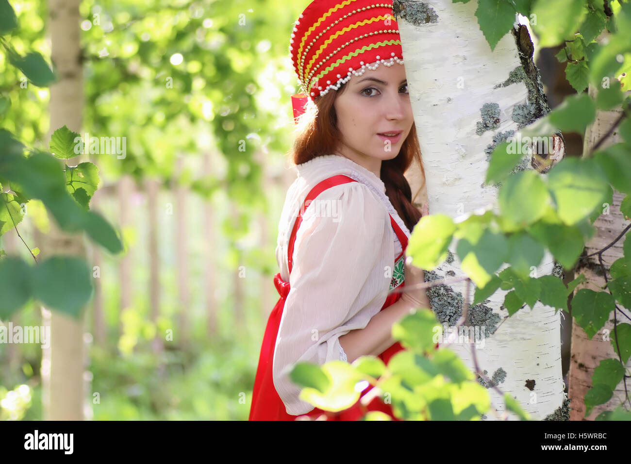 Slav in traditional dress hiding behind trees Stock Photo - Alamy