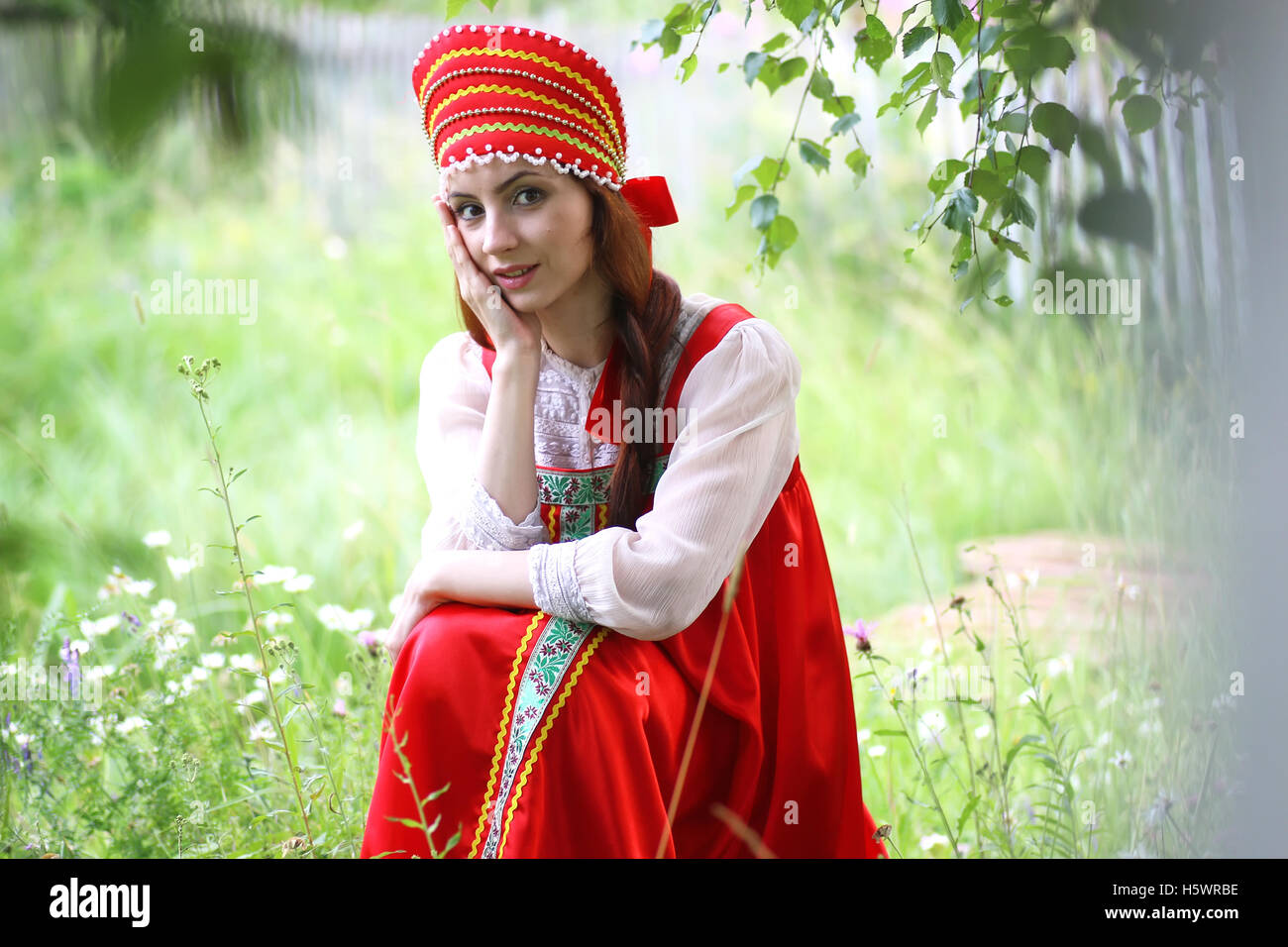 Slav in traditional dress is sitting in nature Stock Photo - Alamy