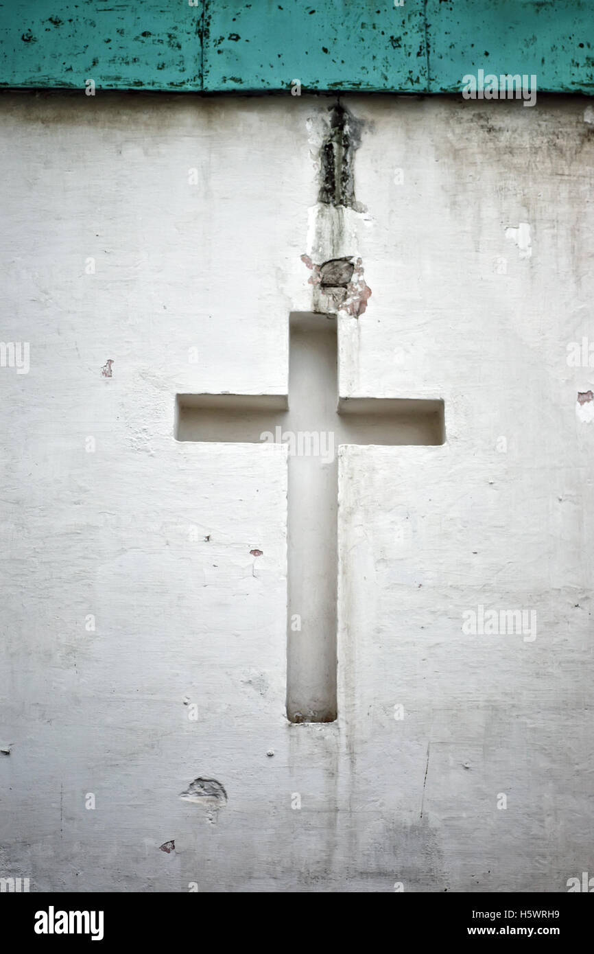 Cross figure religion wall Stock Photo - Alamy