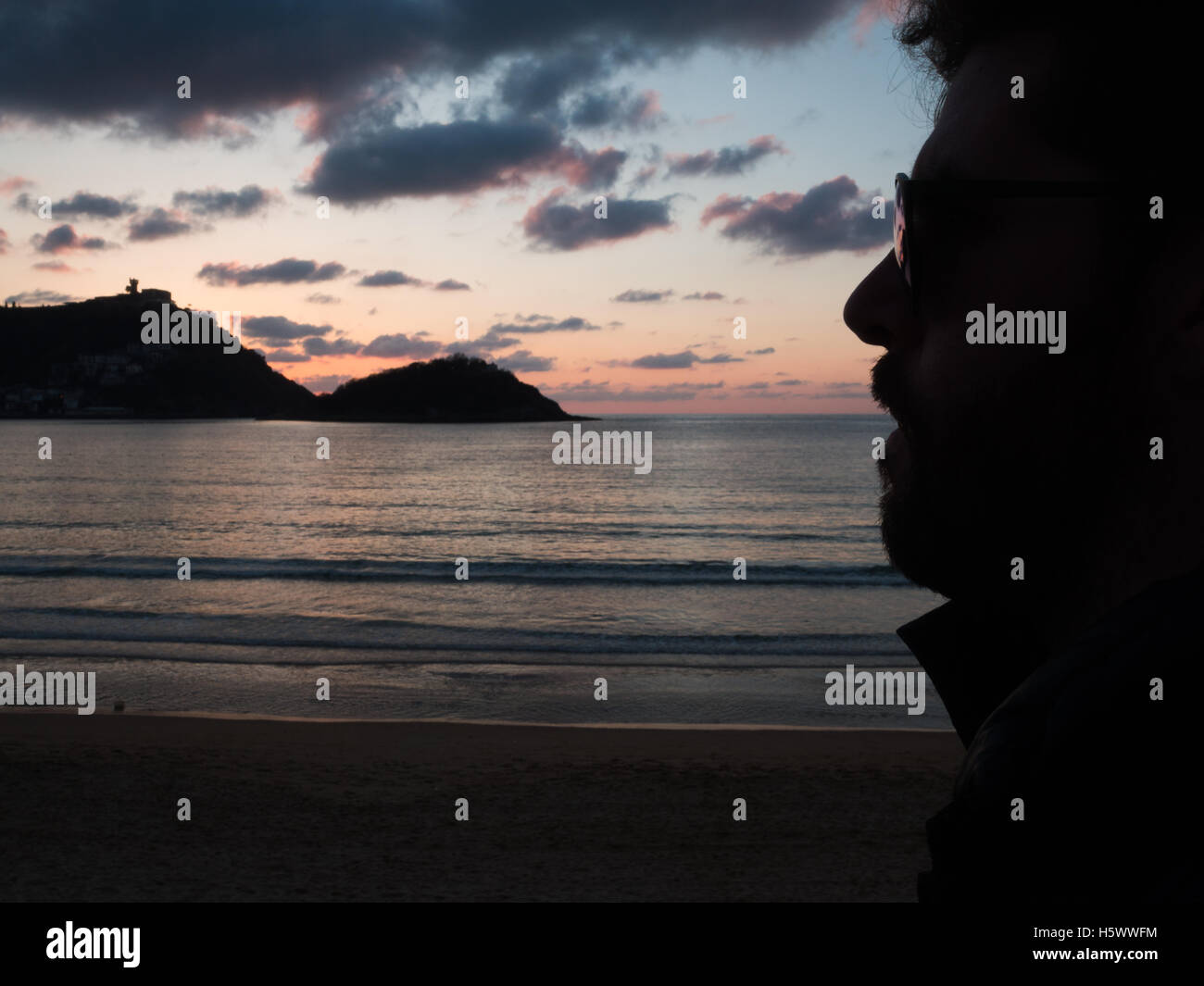 Man profile with sunset over the sea in background Stock Photo - Alamy