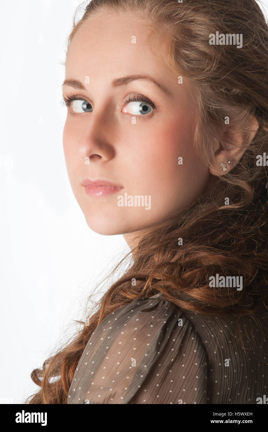 Serious young woman looking over shoulder Stock Photo - Alamy