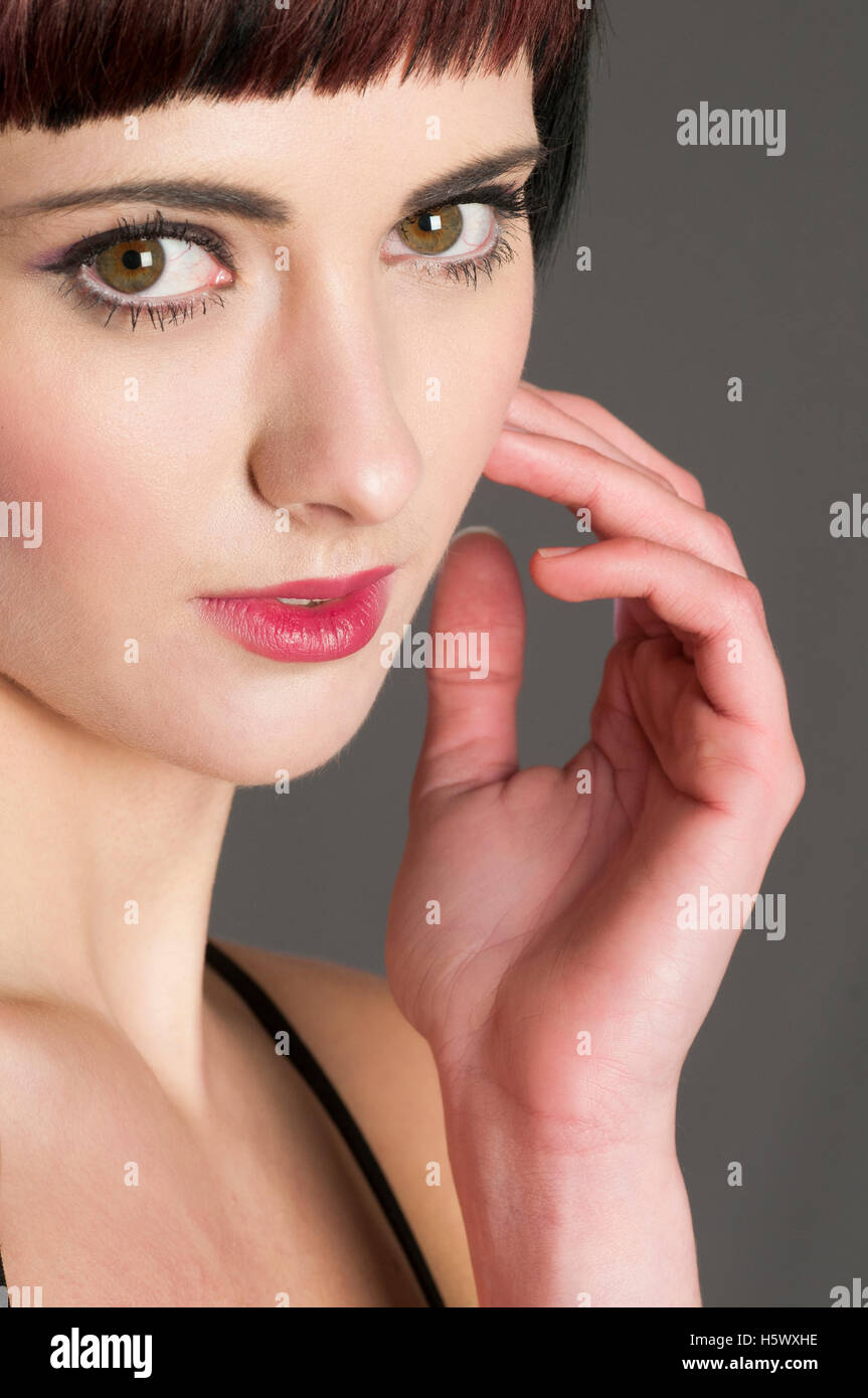 Beautiful young woman hand touching face Stock Photo - Alamy