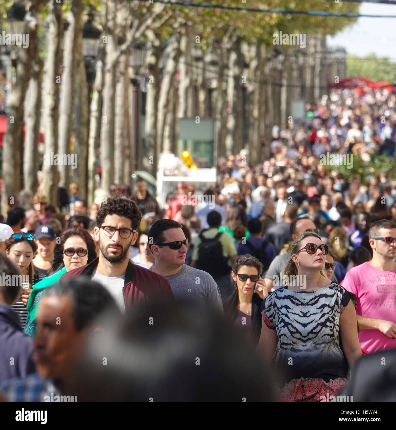Thousands of people walking over Champs Elysees boulevard in Paris ...