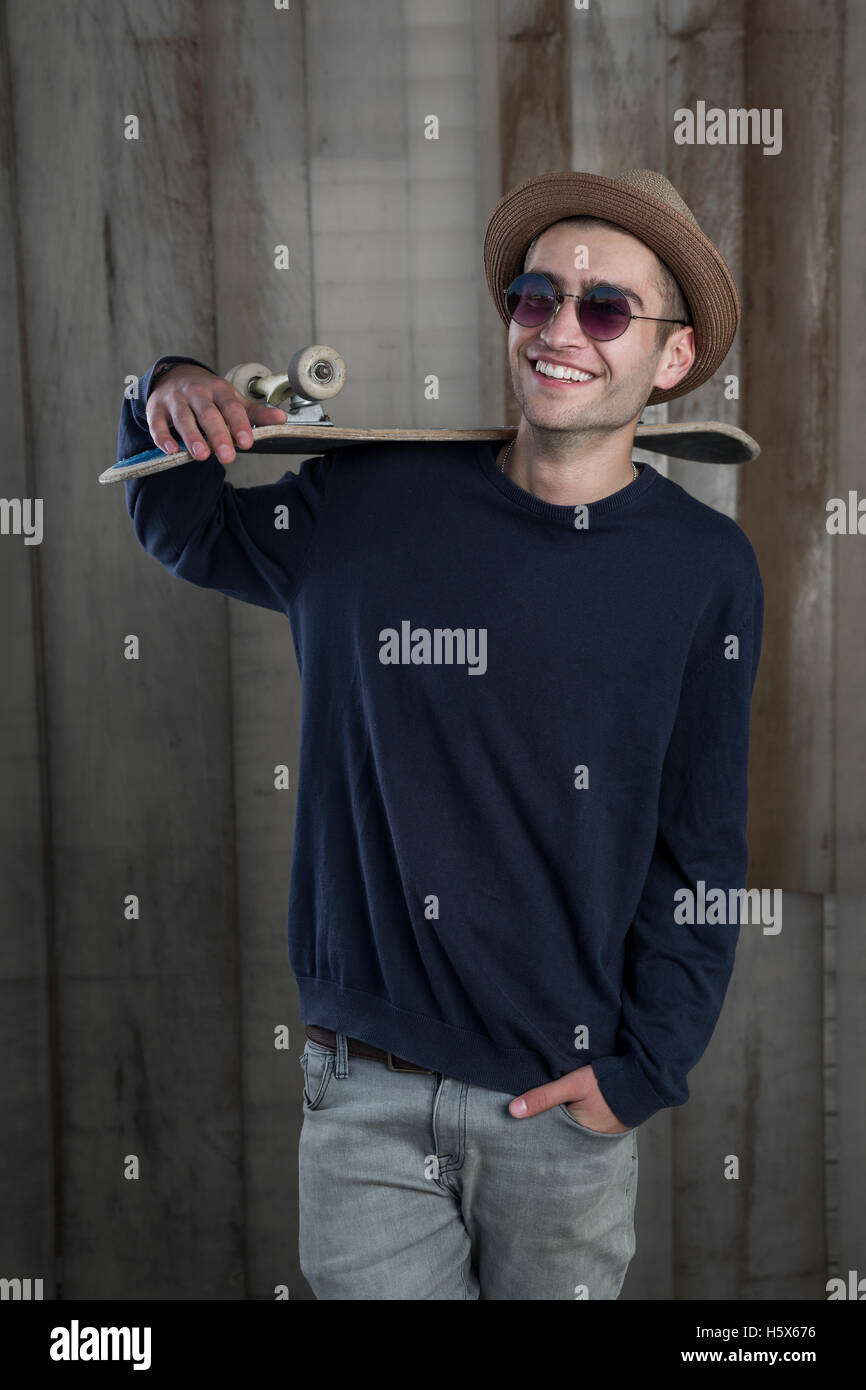 fashionable guy with skateboard Stock Photo - Alamy