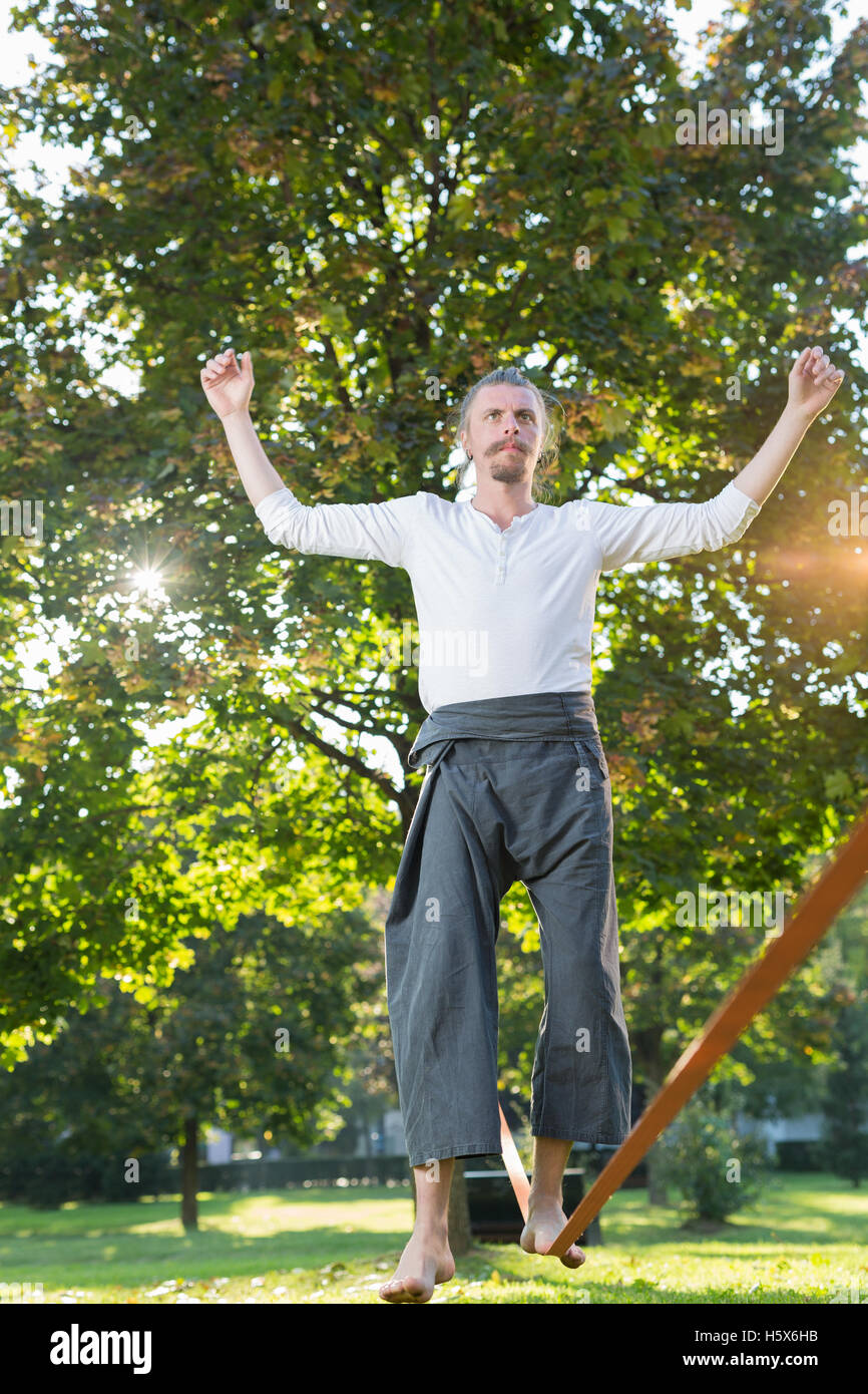 Slacklining is a practice in balance that typically uses nylon or ...
