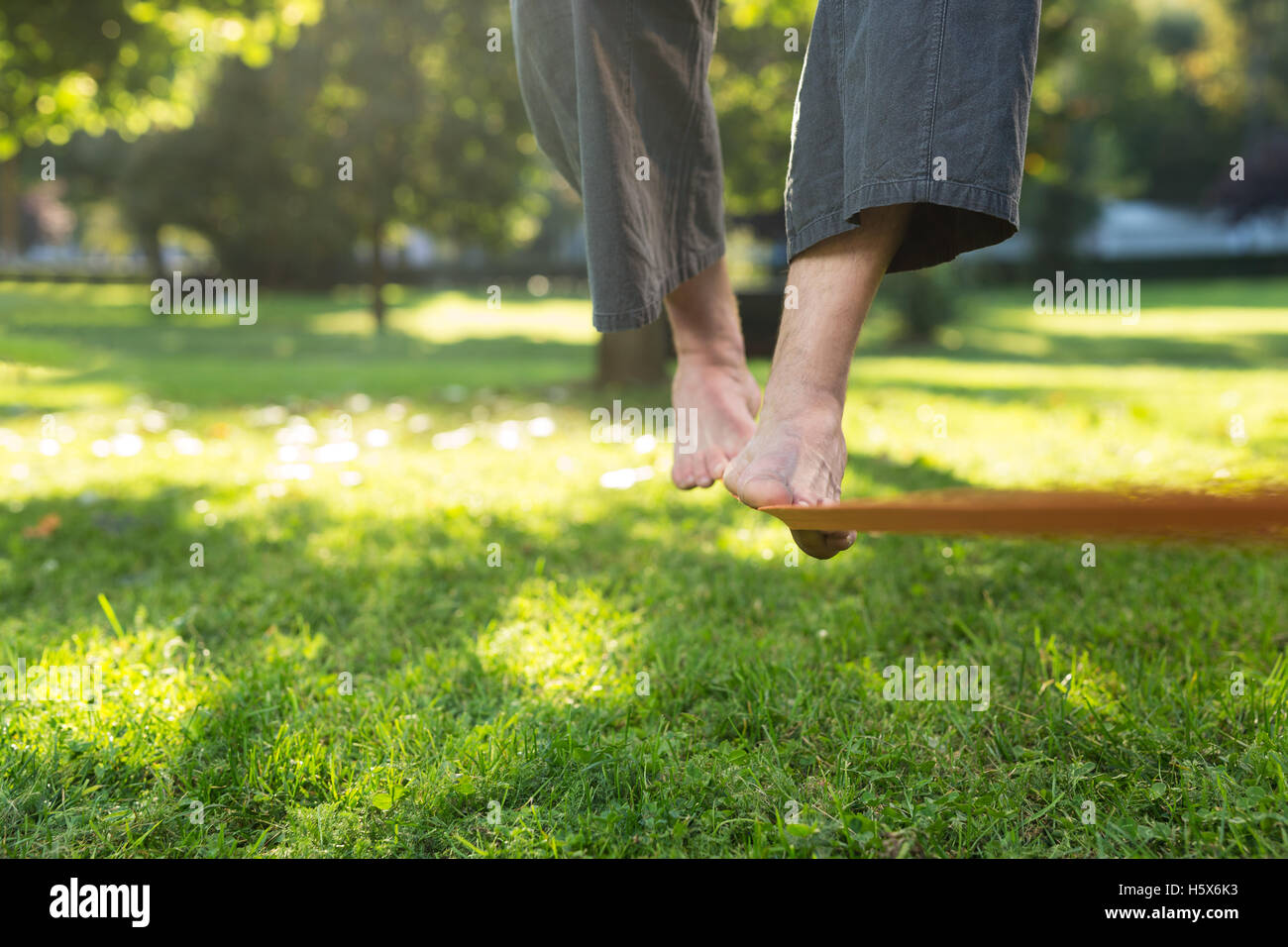 Slacklining is a practice in balance that typically uses nylon or ...