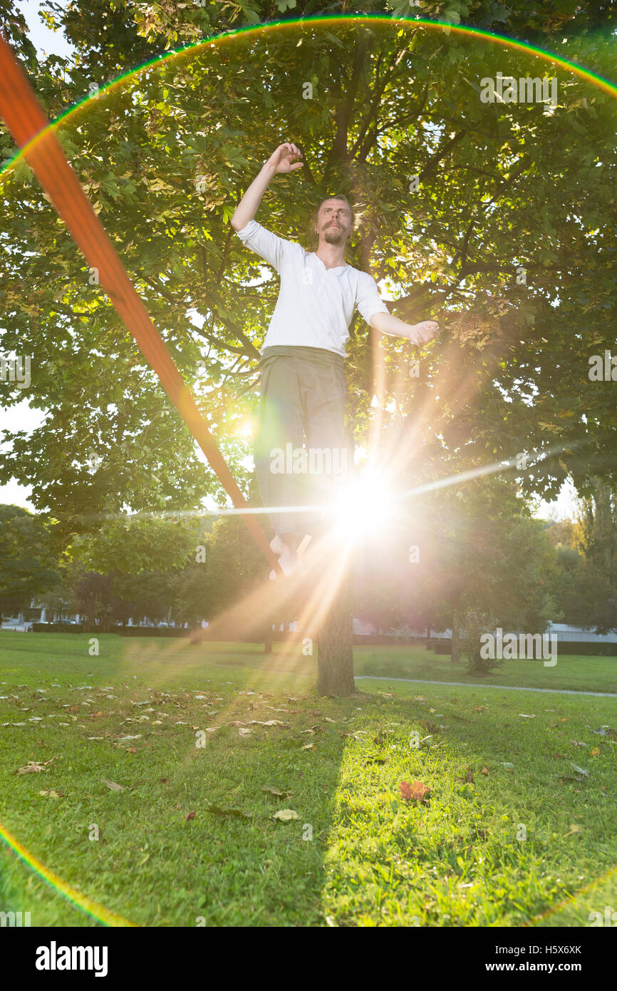 Portrait of man on slackline. Slacklining is a practice in balance ...