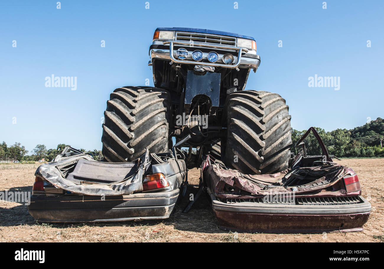 Monster truck over cars. Blue sky Stock Photo - Alamy