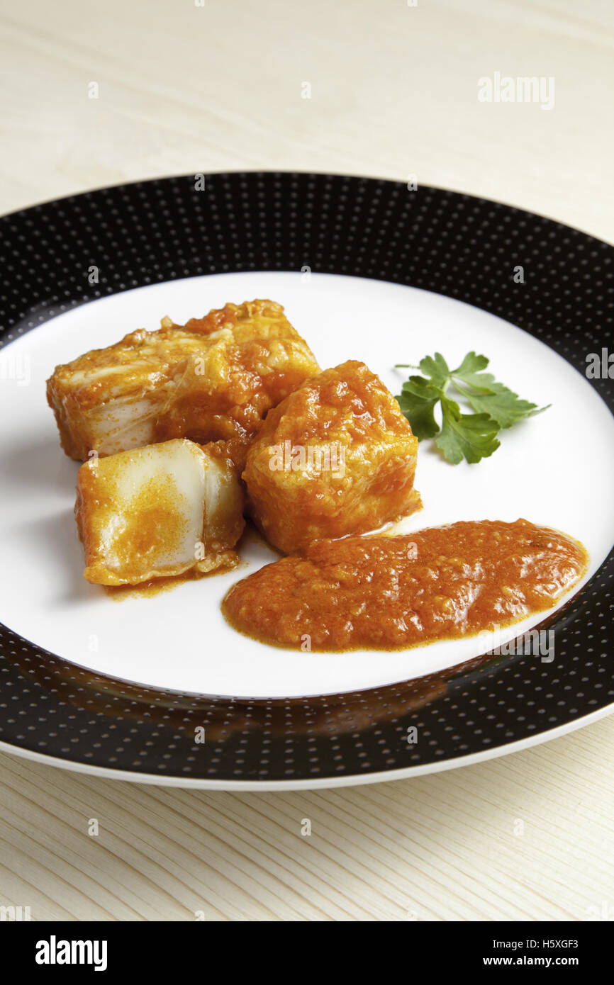 Presentation of fish in the restaurant, detail of cod with tomato ...