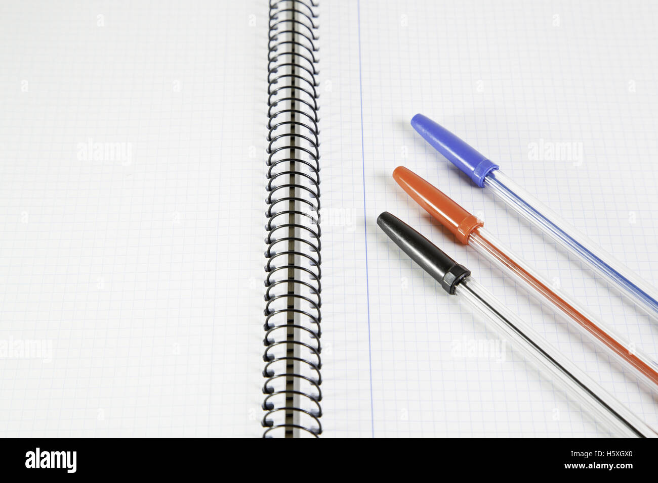 Three basic color pens on a notebook, detail of school for the ...