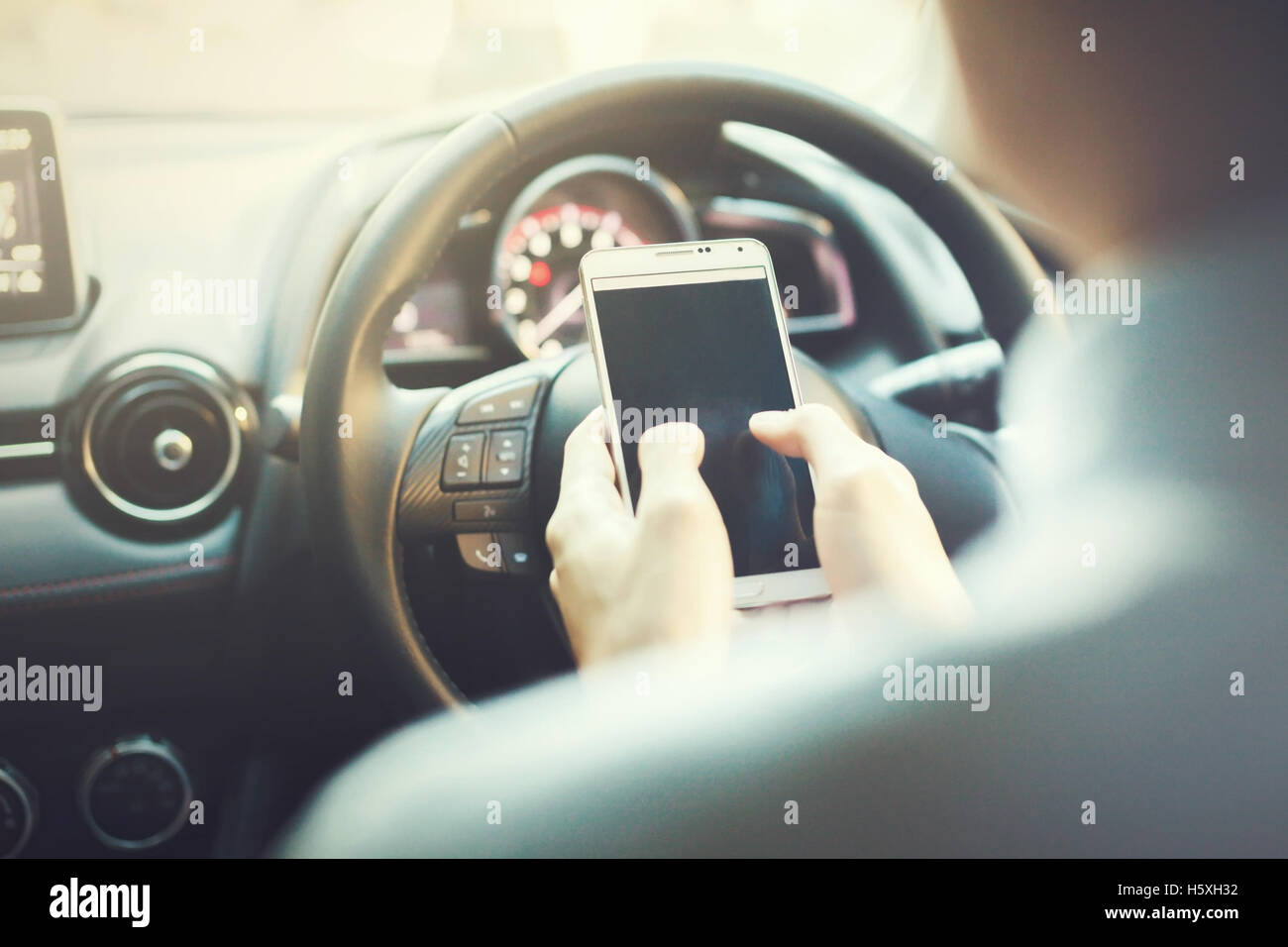 man using phone while driving the car (selective focus ...