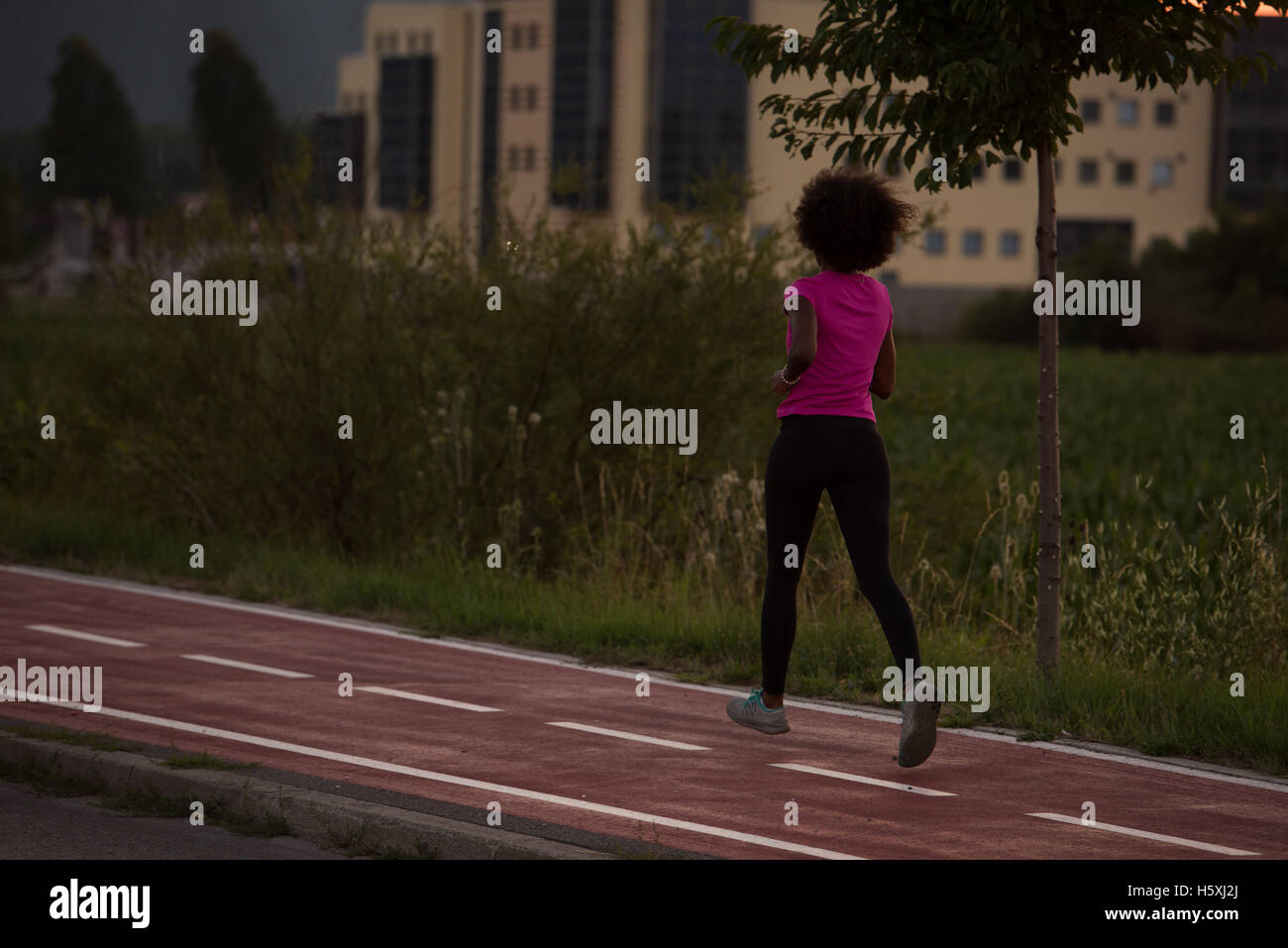 young beautiful African American woman enjoys running outside beautiful ...