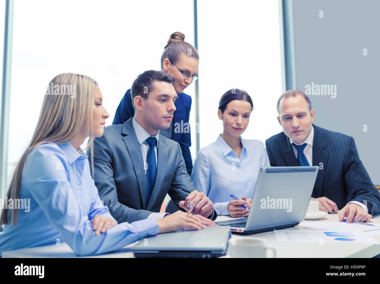 business team with laptop having discussion Stock Photo - Alamy