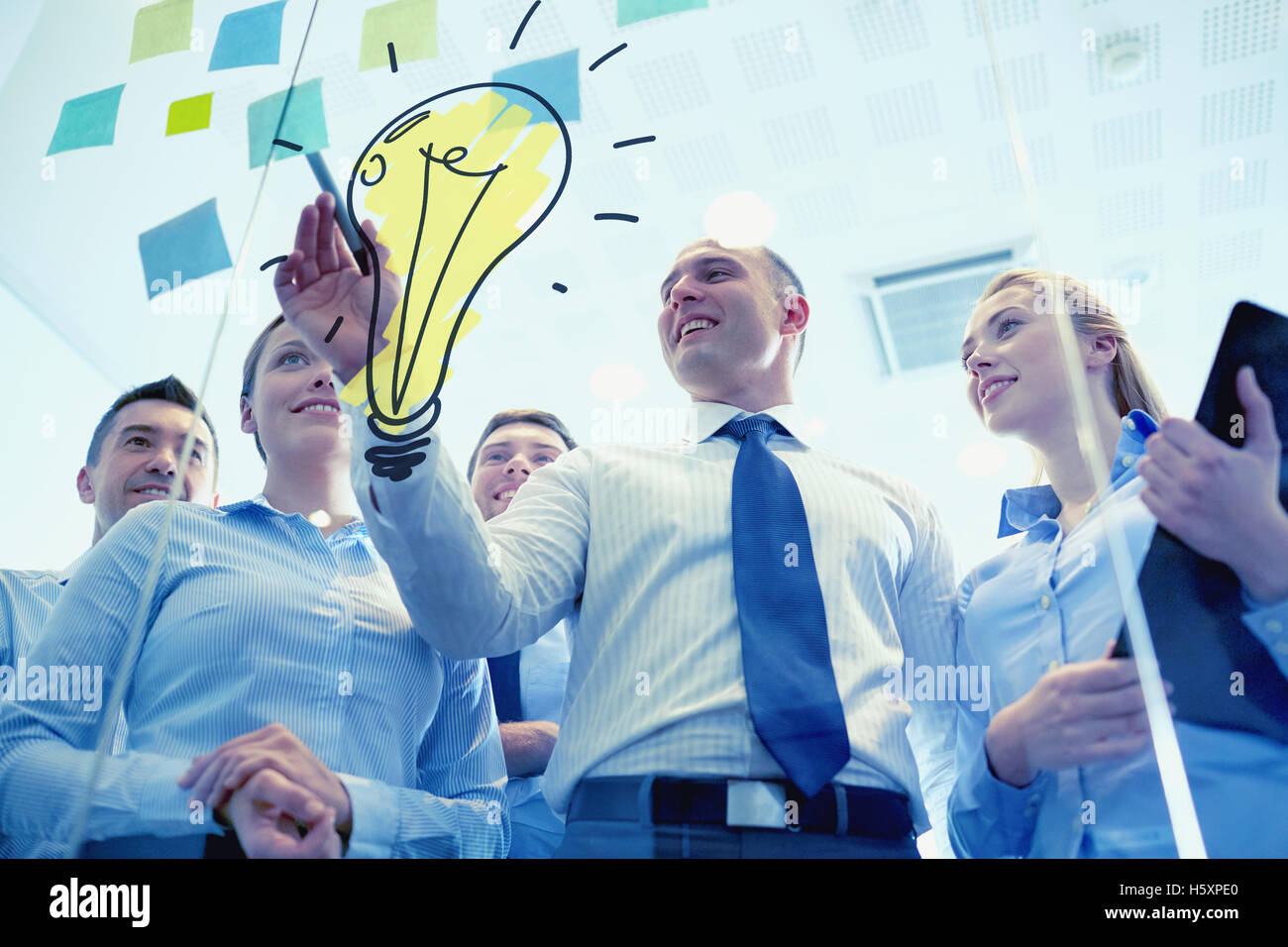 smiling business people with marker and stickers Stock Photo - Alamy