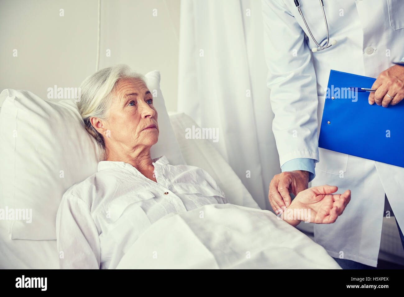 doctor checking senior woman pulse at hospital Stock Photo - Alamy