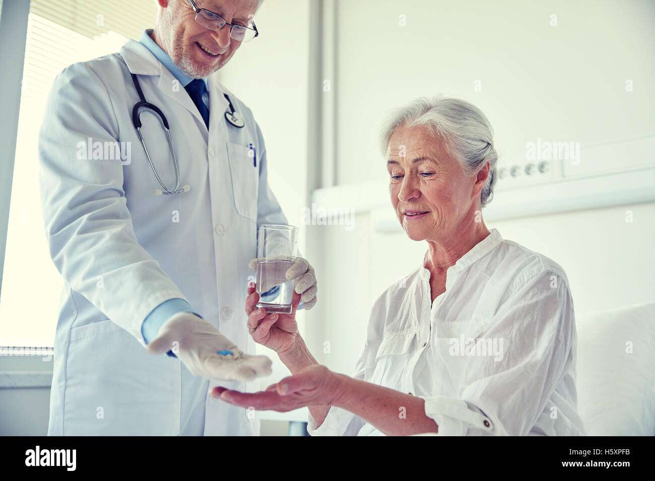 doctor giving medicine to senior woman at hospital Stock Photo - Alamy
