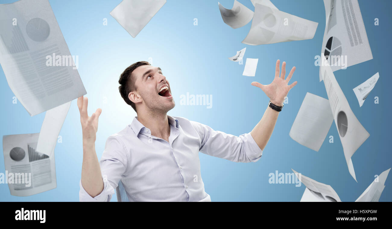 businessman with falling papers Stock Photo - Alamy