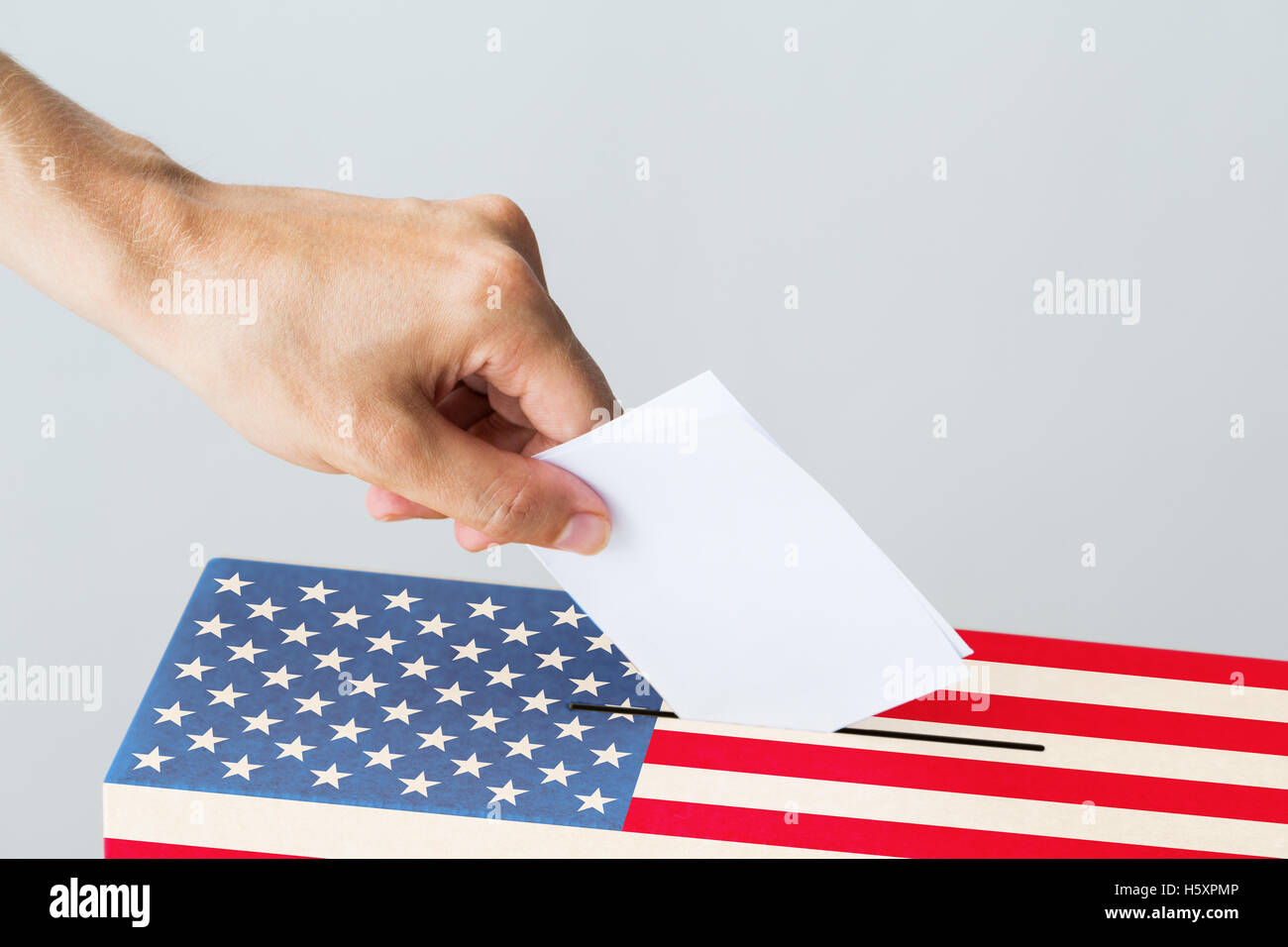 man putting his vote into ballot box on election Stock Photo - Alamy