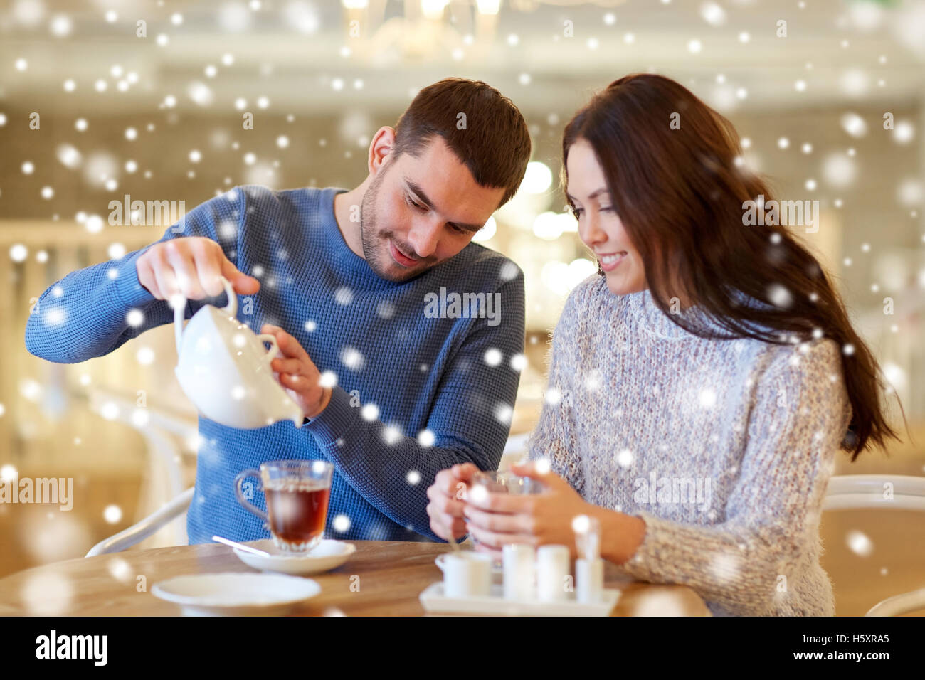 happy couple drinking tea at cafe Stock Photo - Alamy