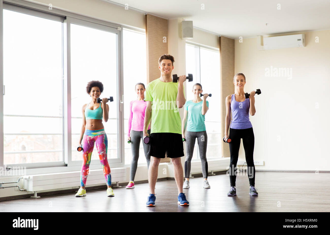 group of smiling people exercising with dumbbells Stock Photo - Alamy
