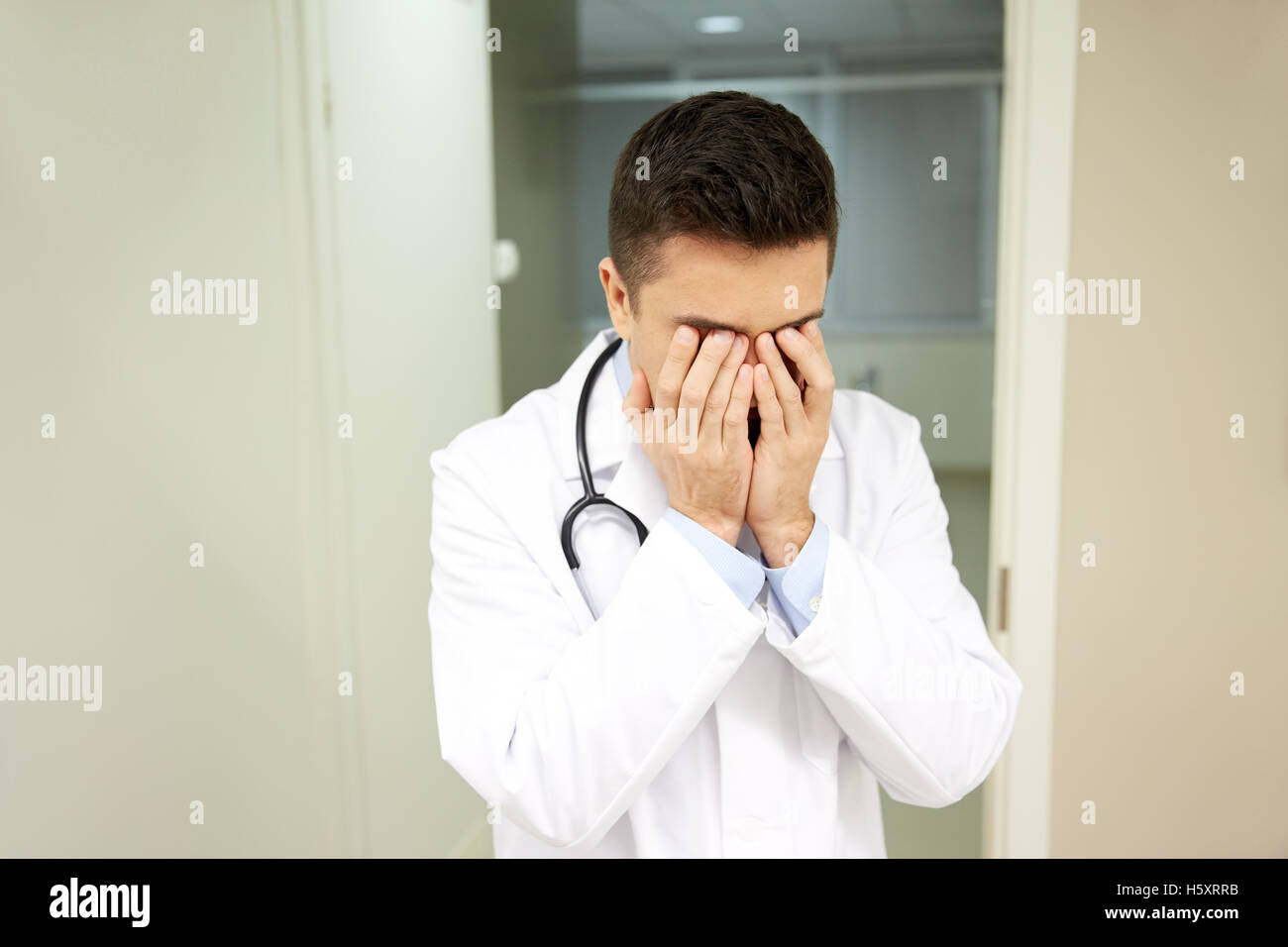 sad or crying male doctor at hospital ward Stock Photo - Alamy