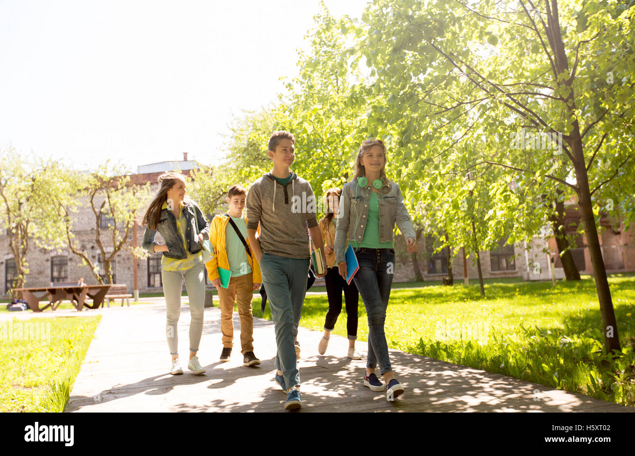 group of happy teenage students walking outdoors Stock Photo - Alamy