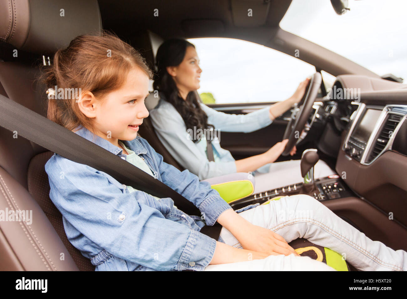 happy woman with little child driving in car Stock Photo - Alamy