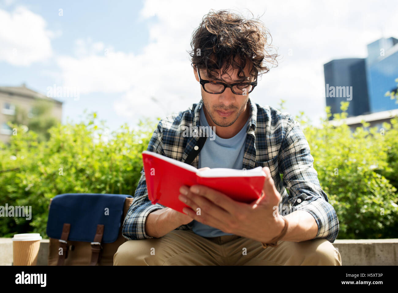 man with notebook or diary writing on city street Stock Photo - Alamy