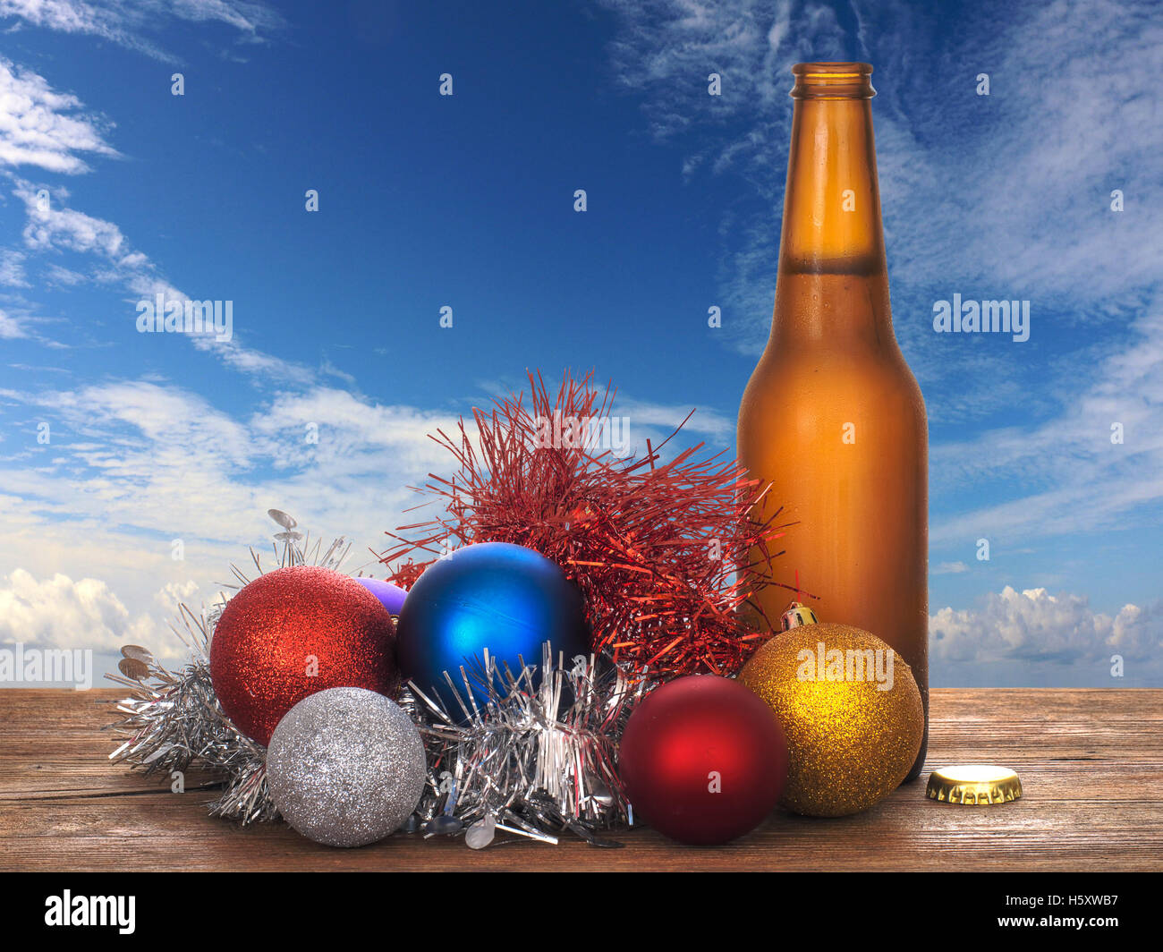 Cold beer Christmas in the sun. With tinsel Stock Photo - Alamy