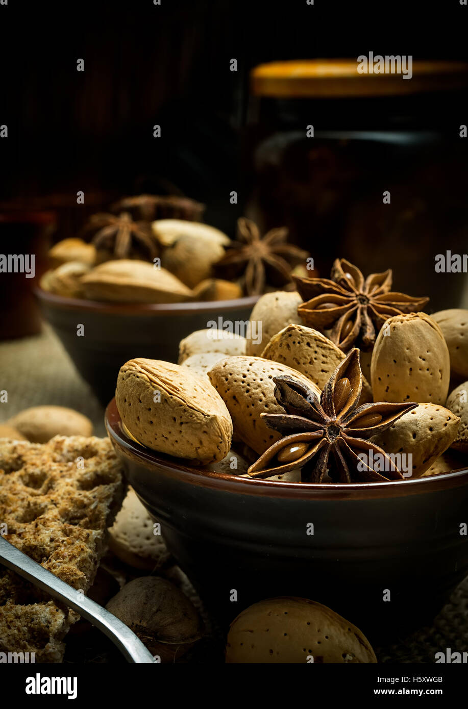 Autumn composition of almonds on a dark rustic background with star ...