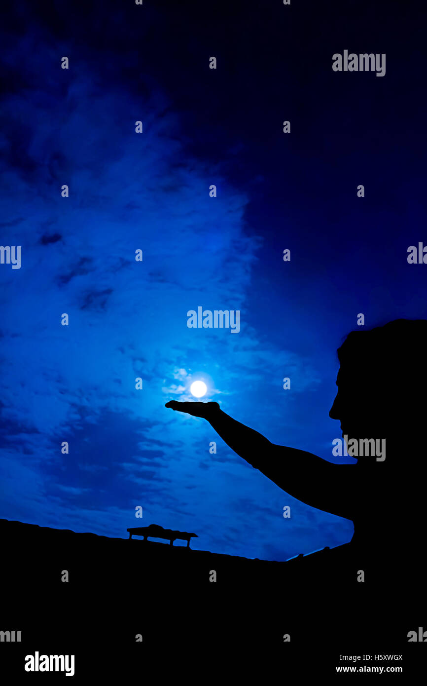 Woman holding full moon in hand against night sky Stock Photo - Alamy