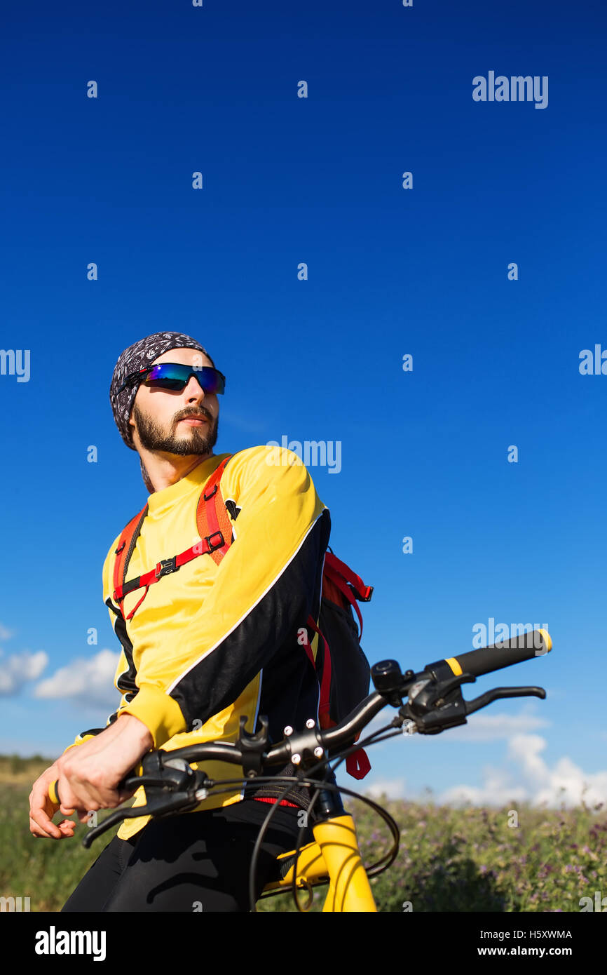 Cyclist riding a bike on an off road to the sunset. Wild landscape ...