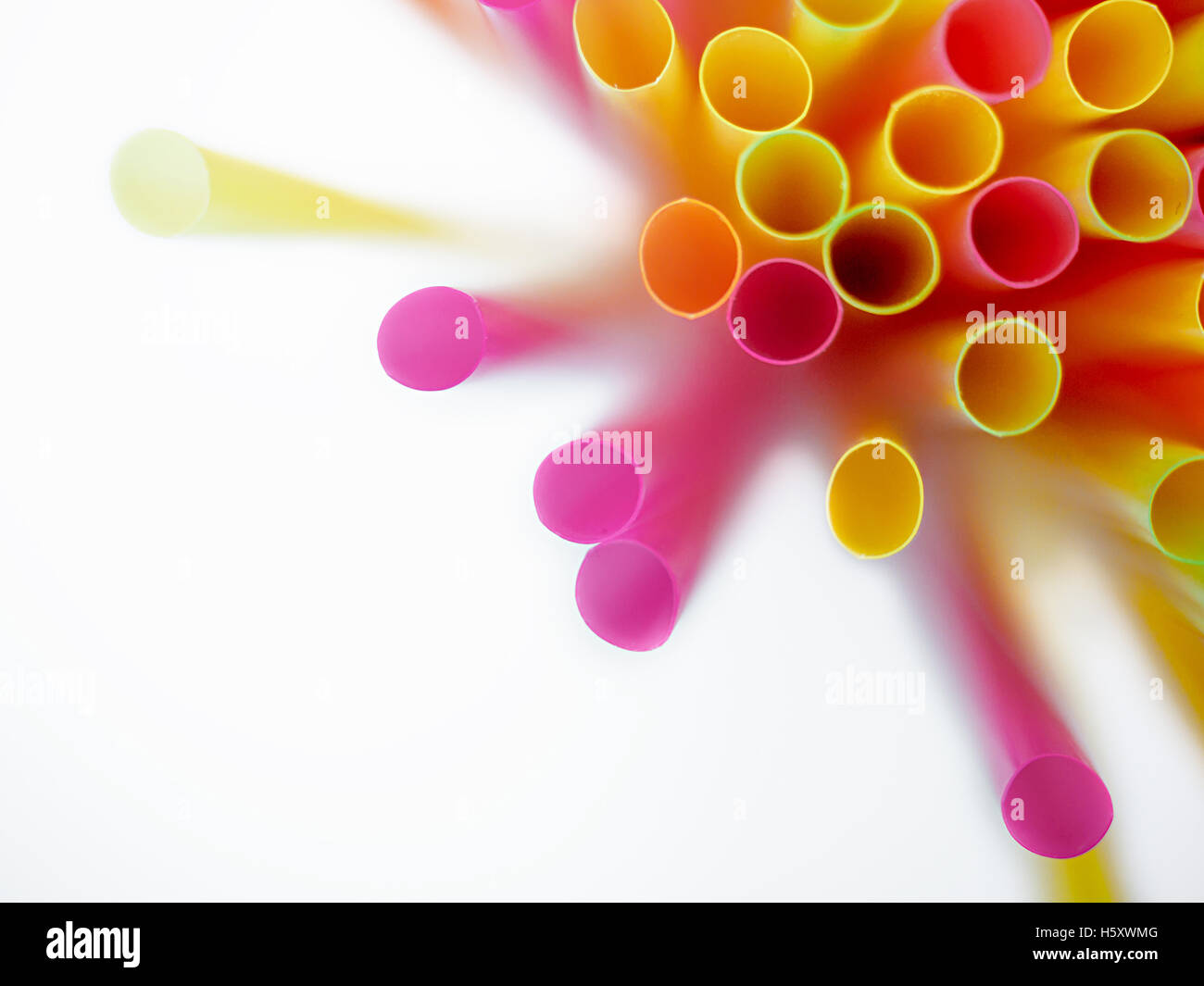 Colored plastic straws on a white background Stock Photo - Alamy