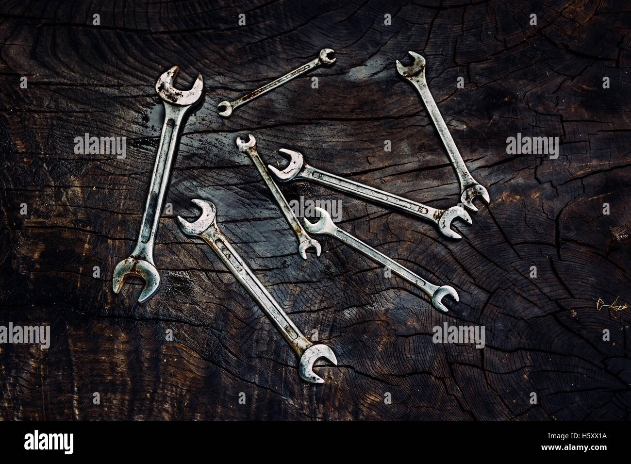 Set of spanners on a dark wooden background Stock Photo - Alamy