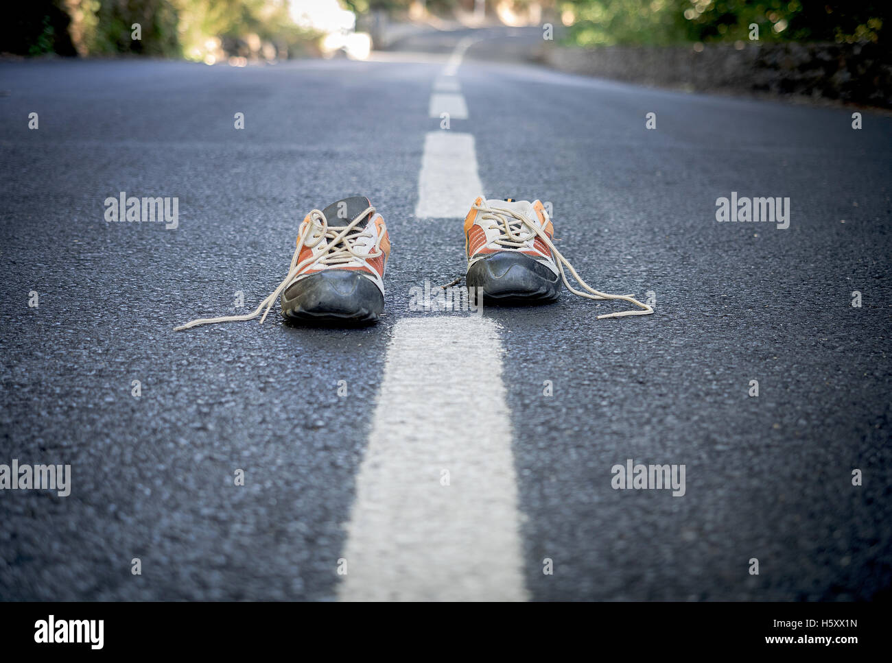 Pair of sneakers on the road Stock Photo - Alamy