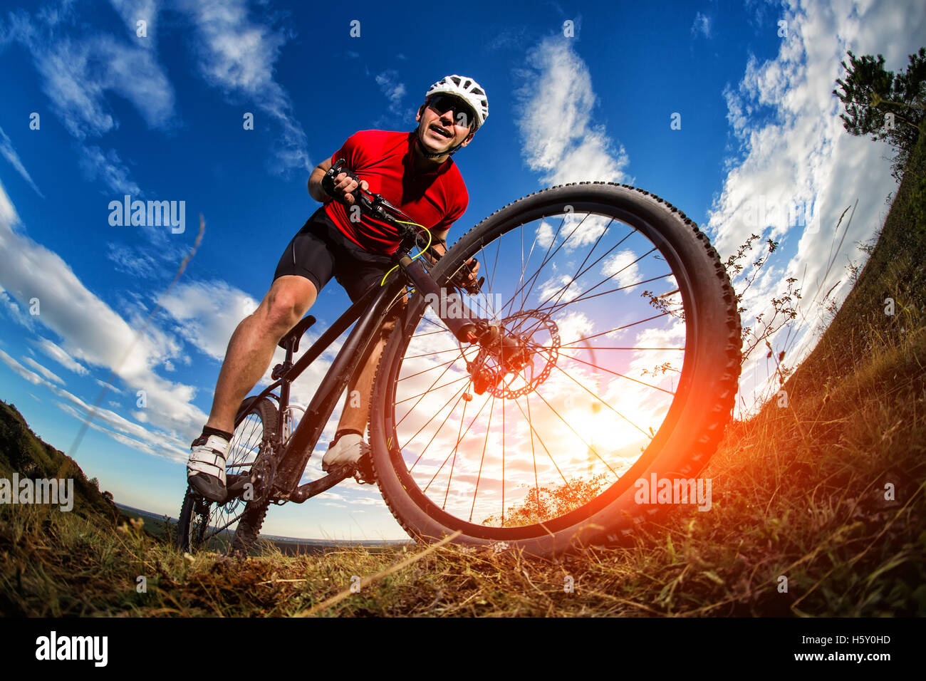 Wide angle view of a cyclist riding a bike on a nature trail in the ...