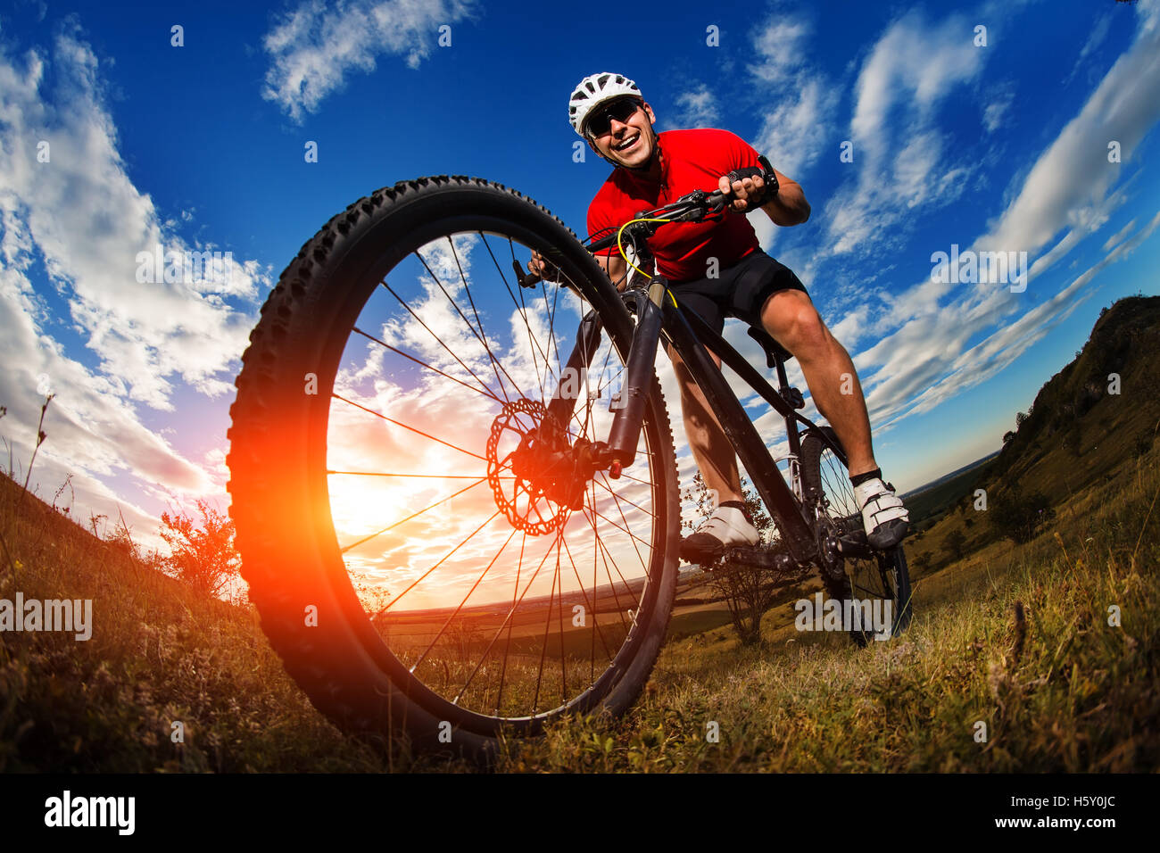 Wide angle view of a cyclist riding a bike on a nature trail in the ...