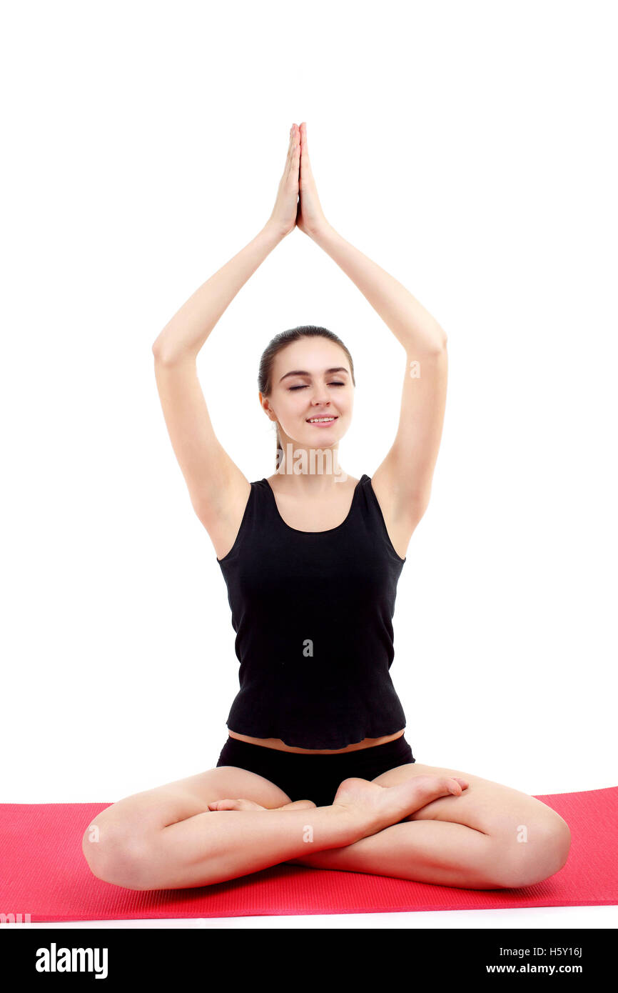 beautiful young woman yoga posing on a studio background Stock Photo ...