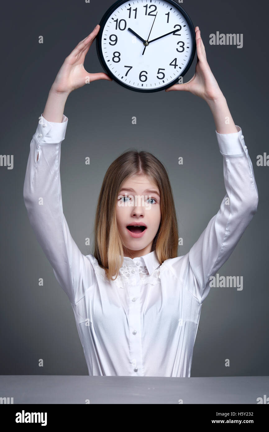 Surprised blondgirl with huge alarm clock on light background Stock ...