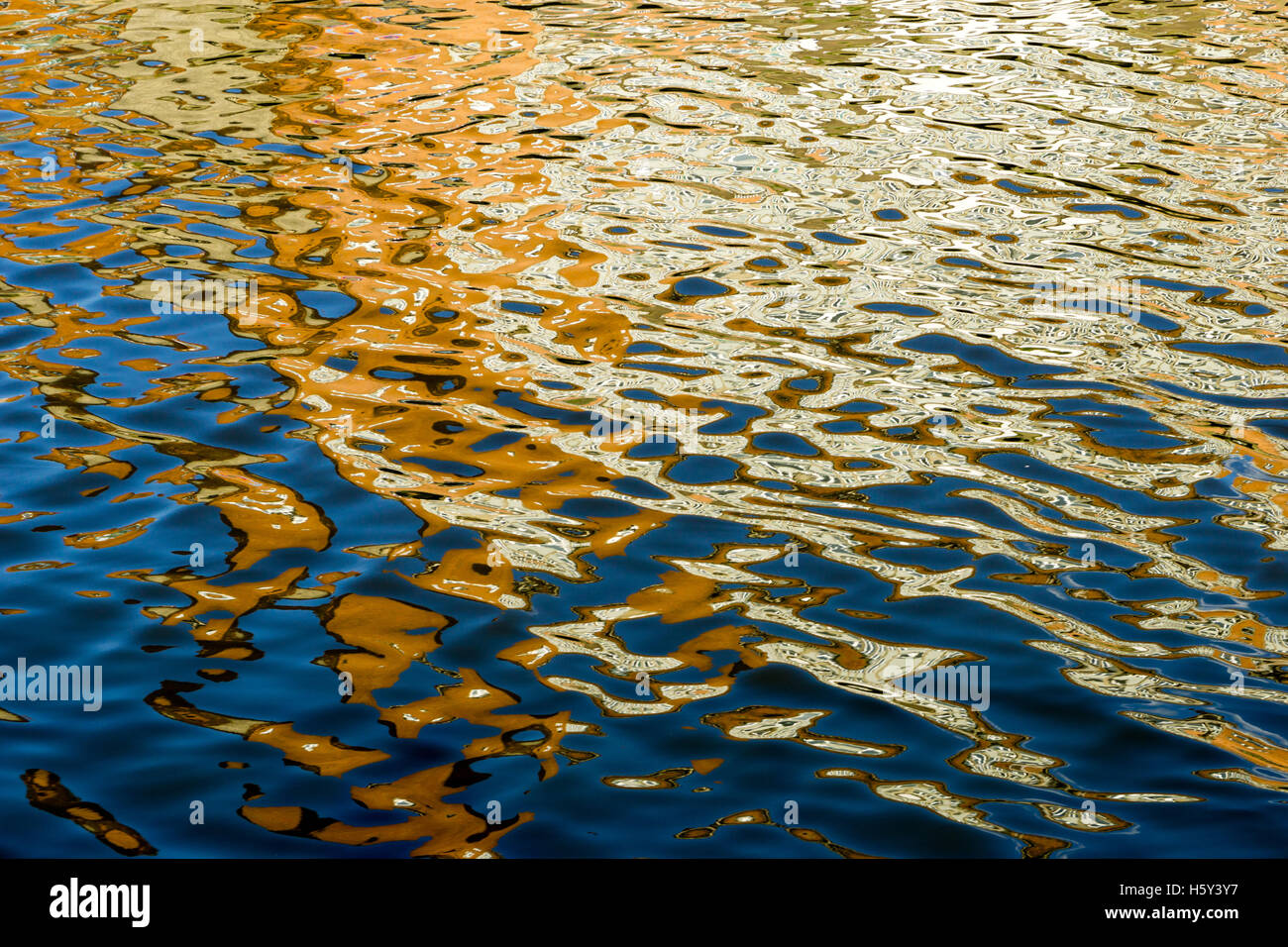 Colored reflections in harbor water Stock Photo - Alamy