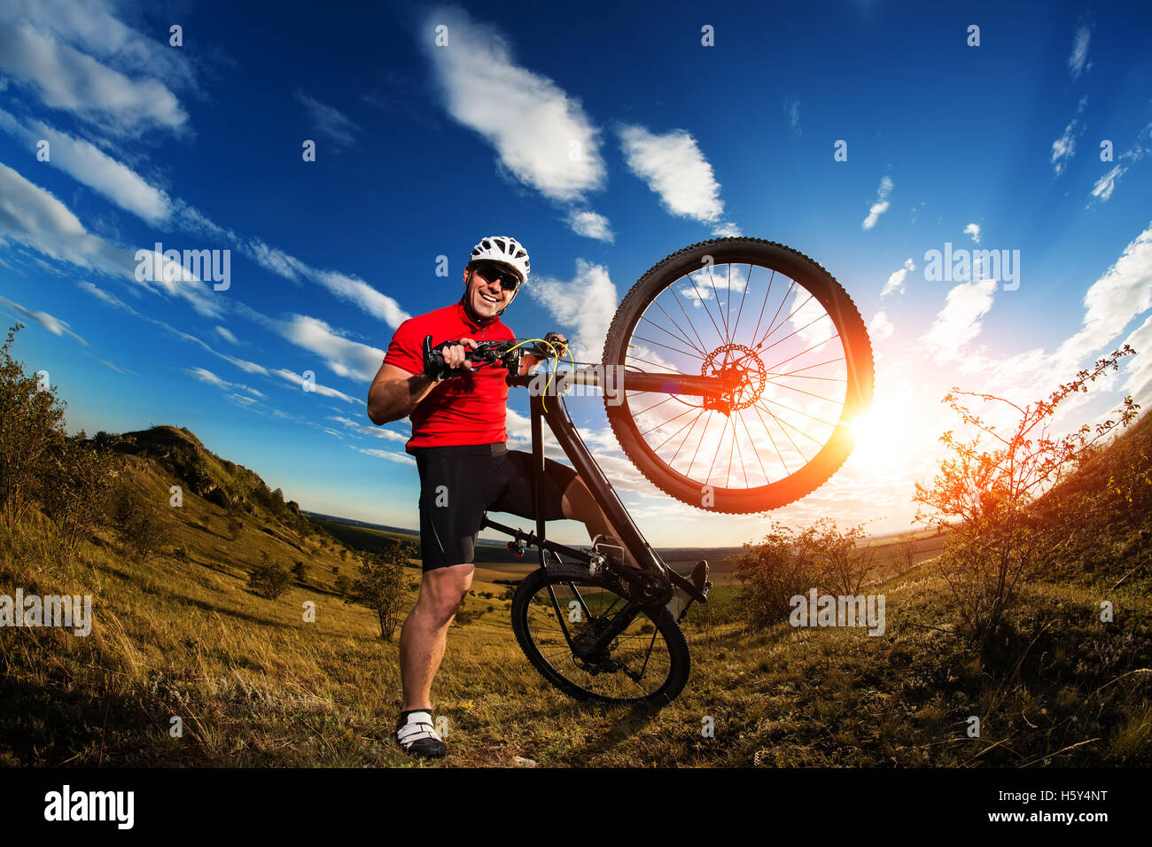 Low angle view of man riding bicycle against sky with clouds against ...