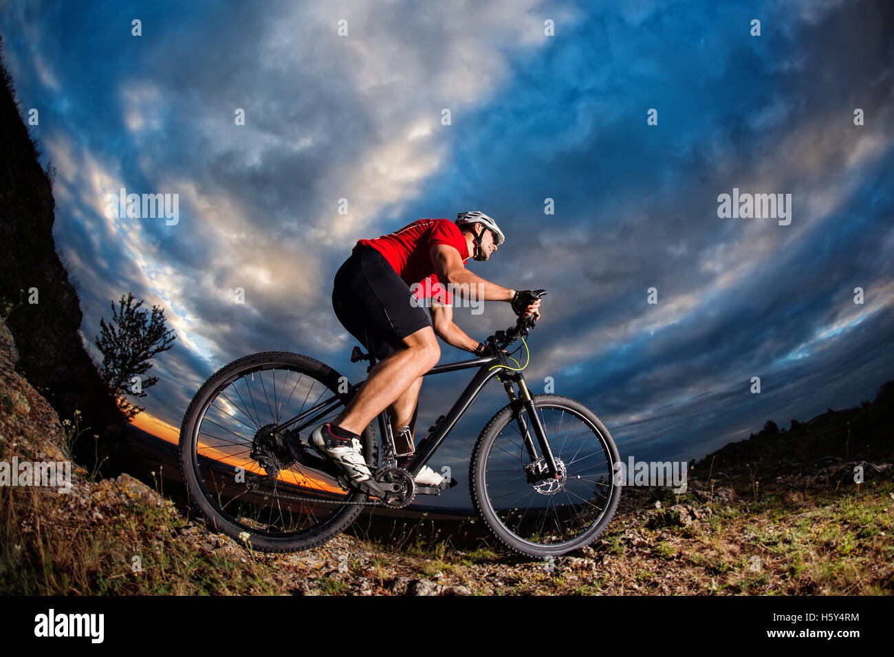 Wide angle view of a cyclist riding a bike on a nature trail in the ...